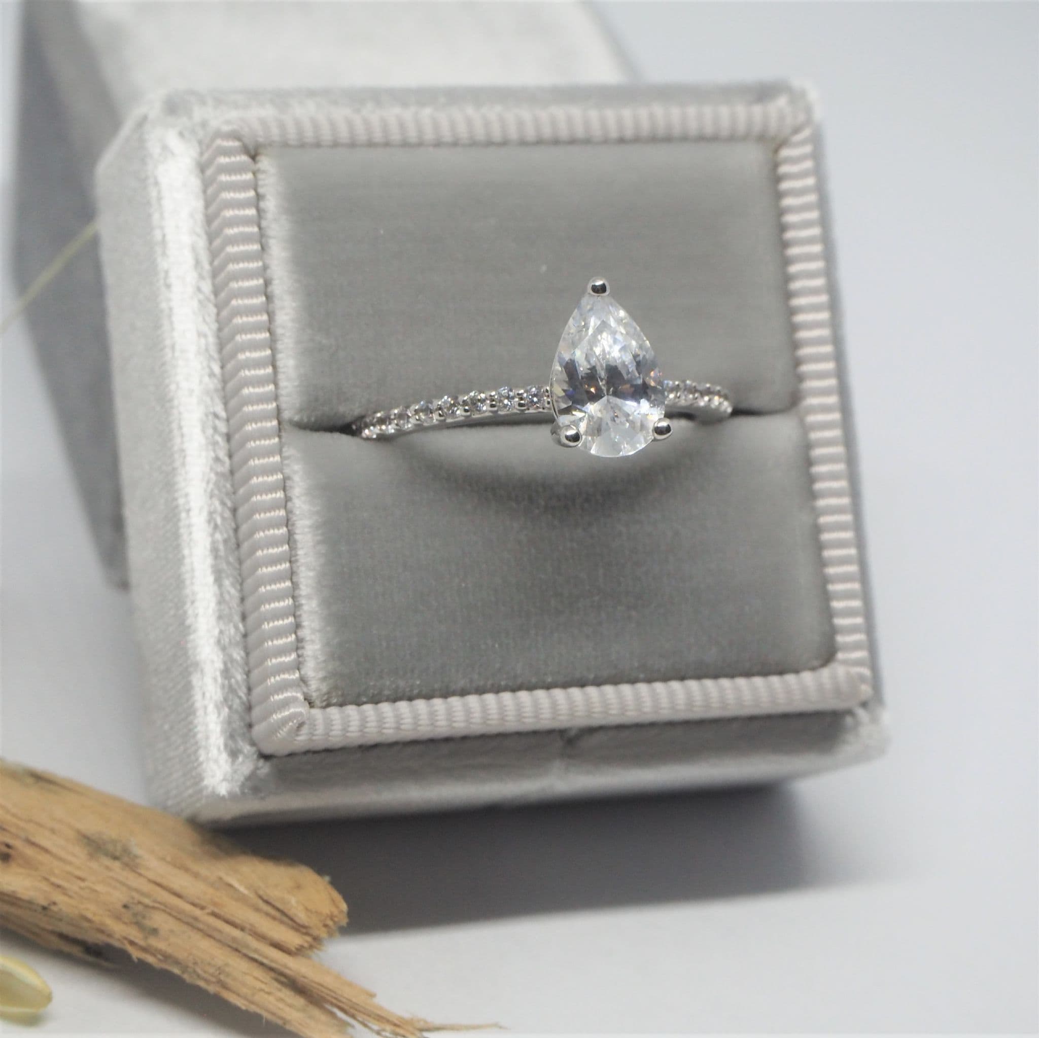 Pear diamond solitaire with diamond shoulders