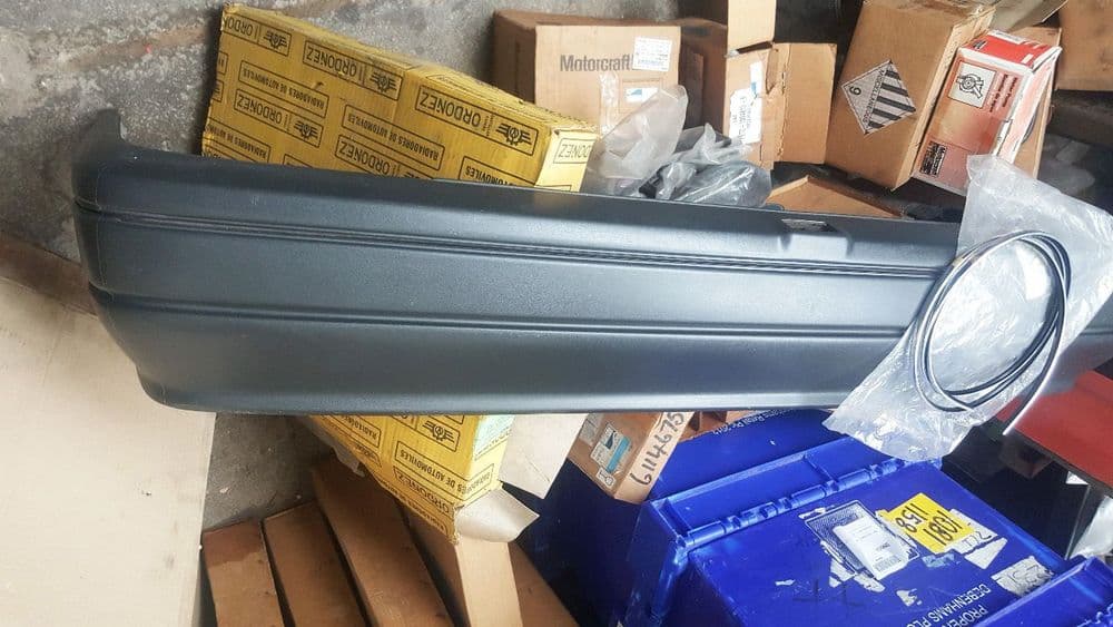New Genuine Rear Bumper in Plastic non Paint with chrome insert
