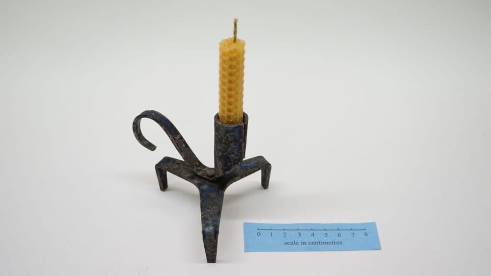 medieval style forged steel tripod candle holder and beeswax candle