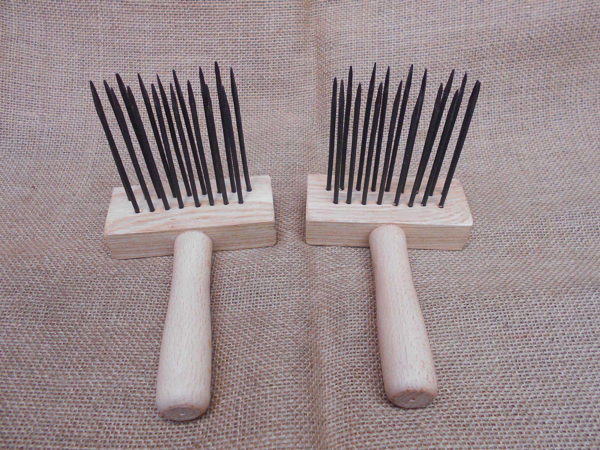 reenactment weaving pair of hand forged black steel wool combs