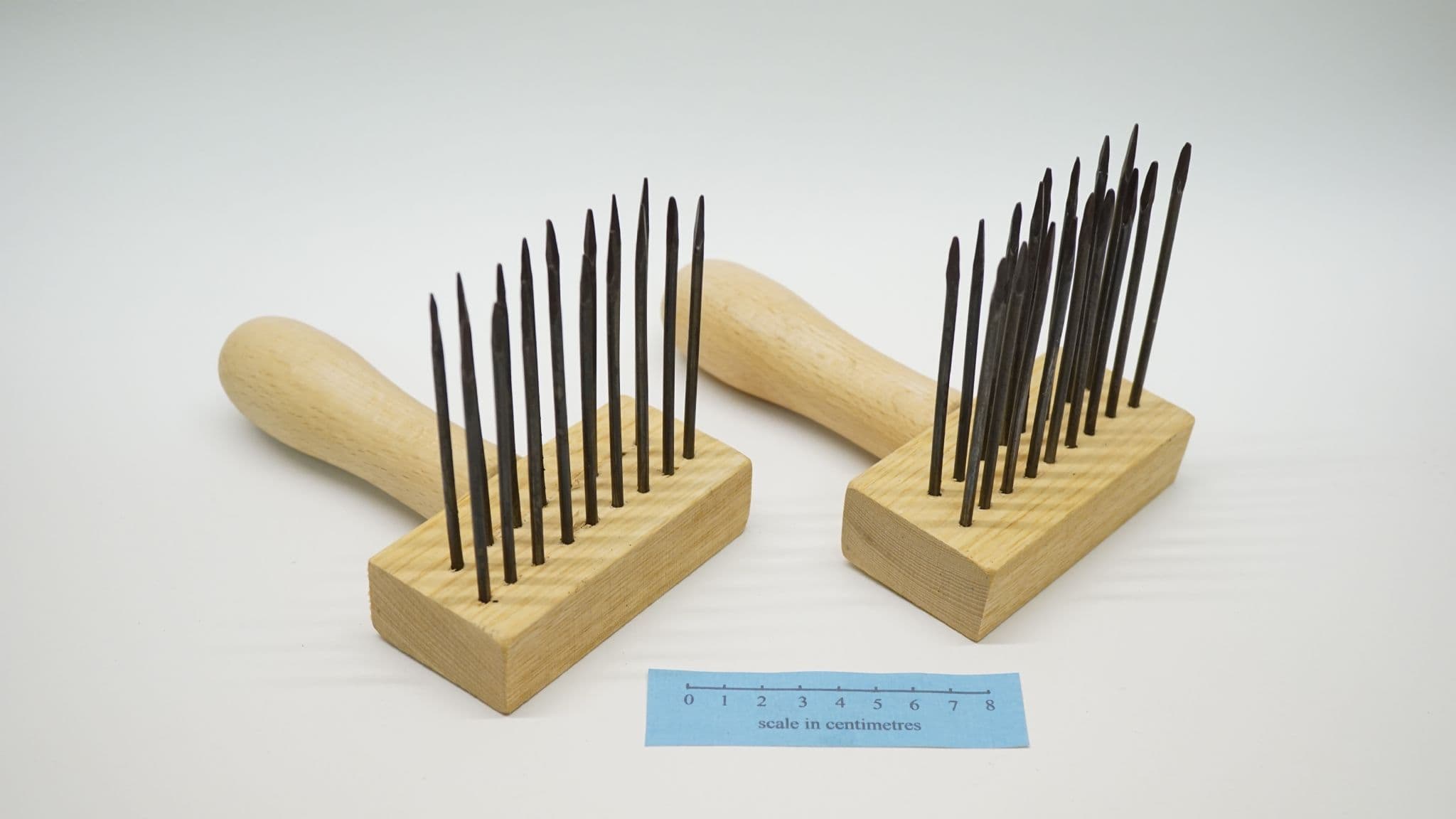 reenactment weaving pair of hand forged black steel wool combs