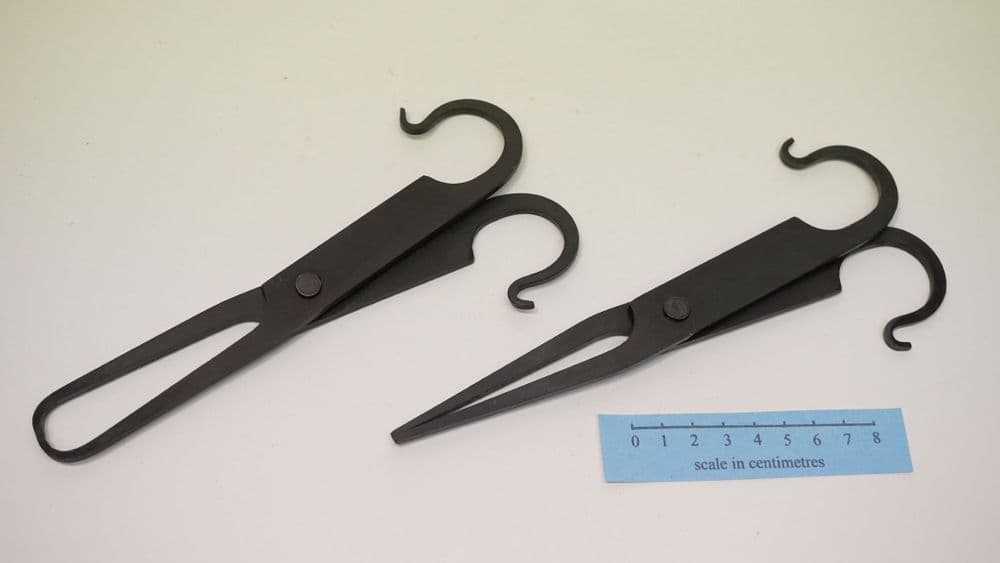 set of two medieval surgical forceps in steel tapered and bowed