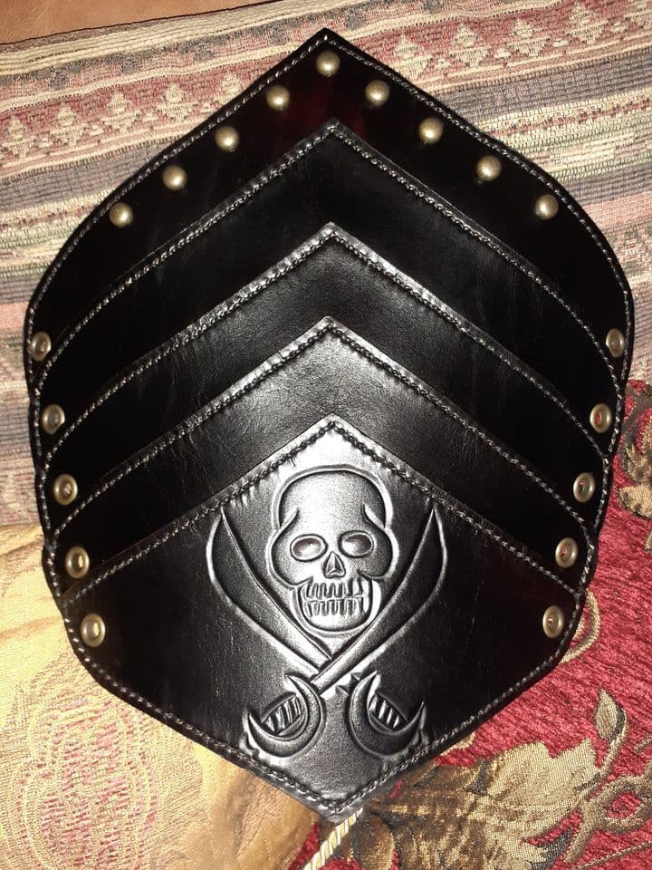 Black studded segmented gauntlet with pirate skull and cross swords ...