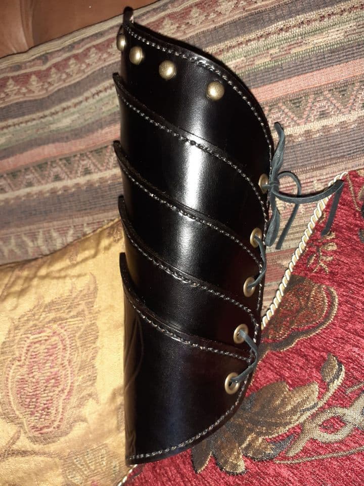 Black studded segmented gauntlet with pirate skull and cross swords ...