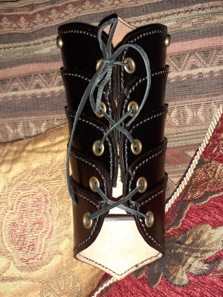 Black studded segmented gauntlet with pirate skull and cross swords ...