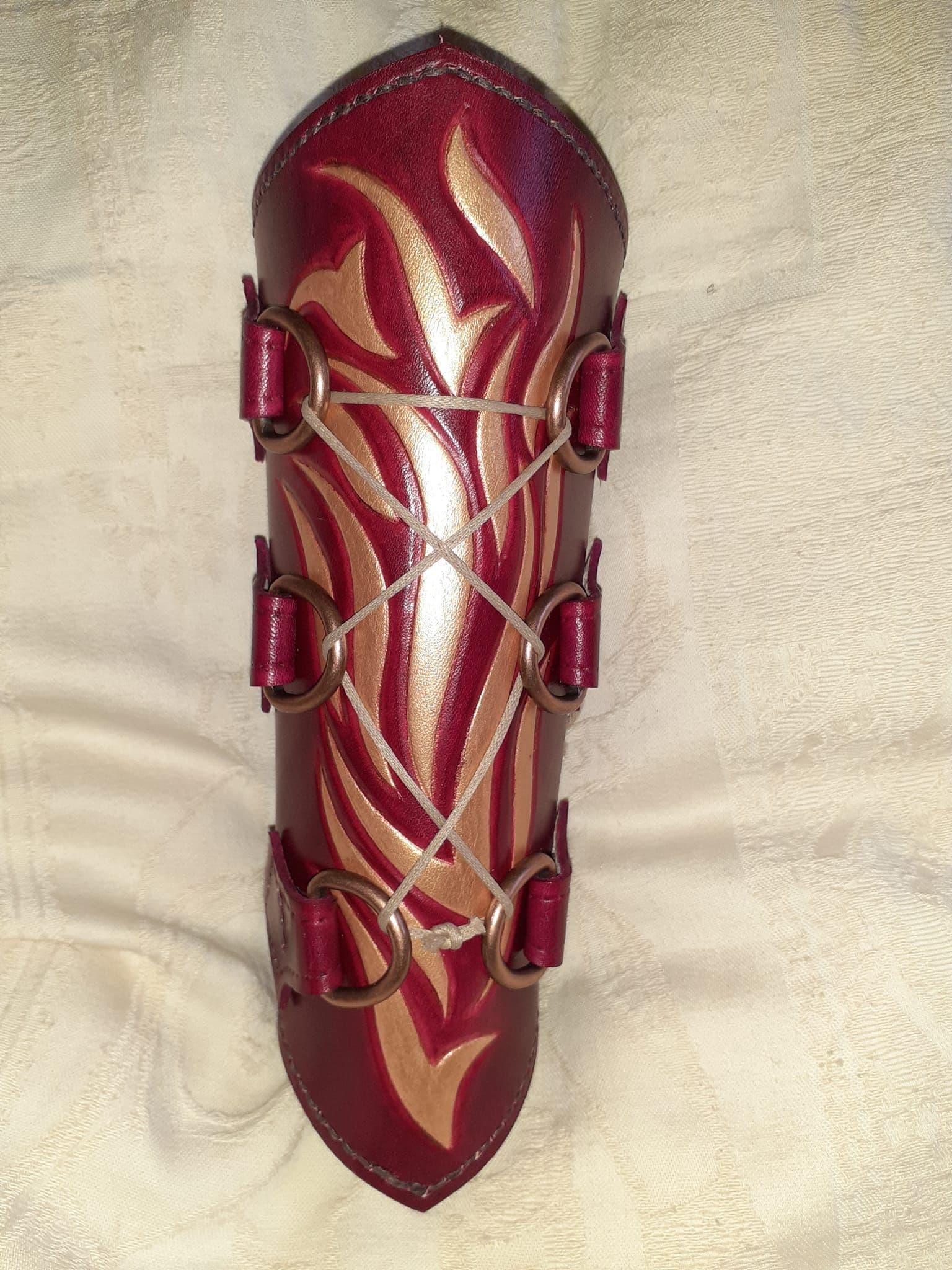 Gauntlet in ox blood with Celtic flame embossing and solid brass D rings