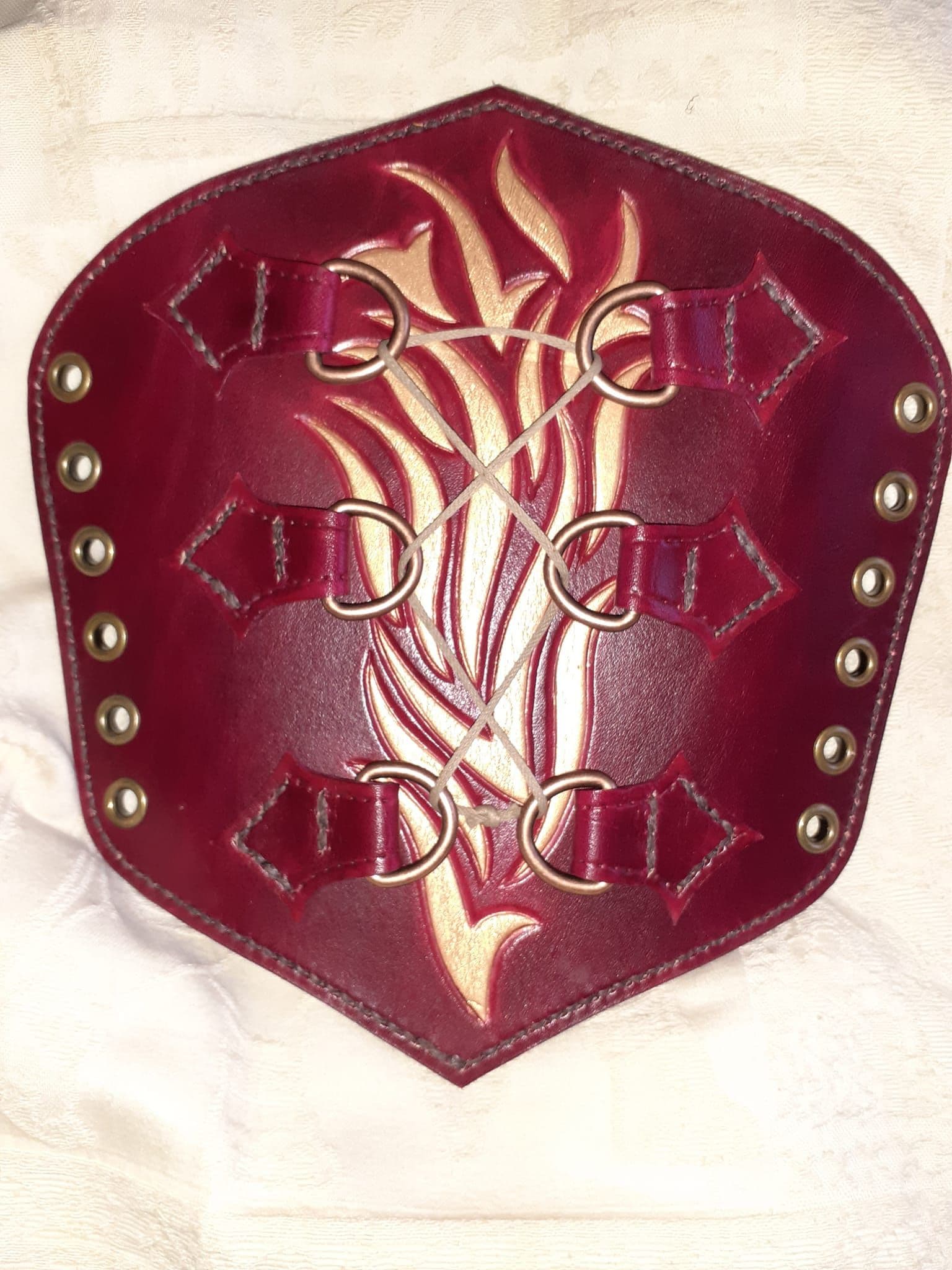 Gauntlet in ox blood with Celtic flame embossing and solid brass D rings