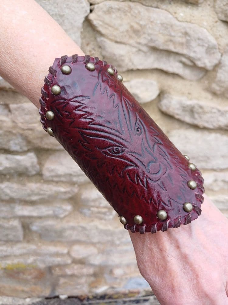 Leather wrist cuff with Wolf head embossing and brass studding