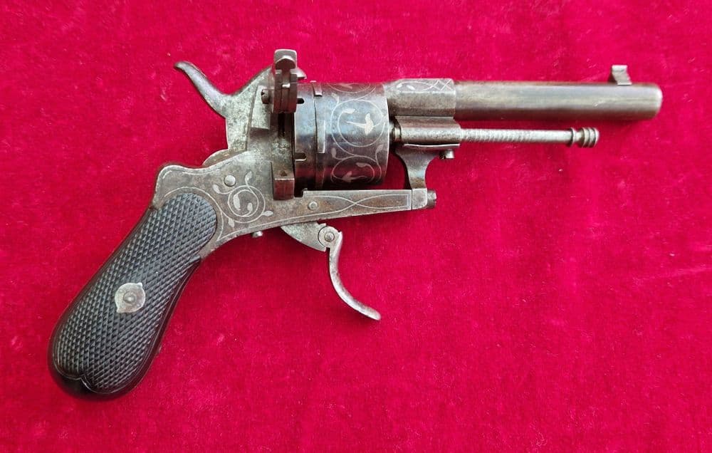A fine 7mm pin-fire double-action revolver inlaid with silver ...