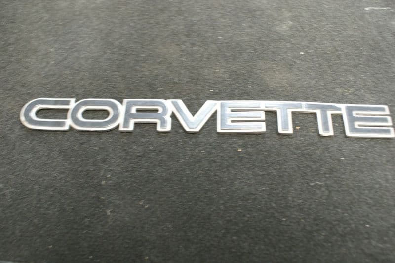 1984-1990 C4 Corvette Rear Bumper Emblem Silver Outline Used