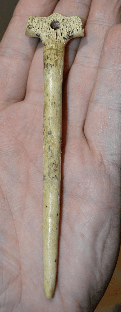 A very large and extremely rare Neolithic ornately carved bone cloak ...