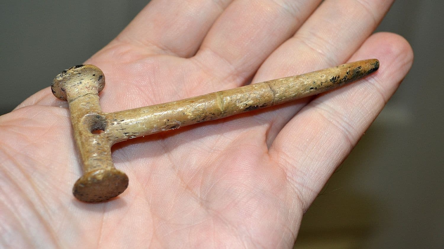 An extremely rare Neolithic ornately carved bone cloak pin with ...