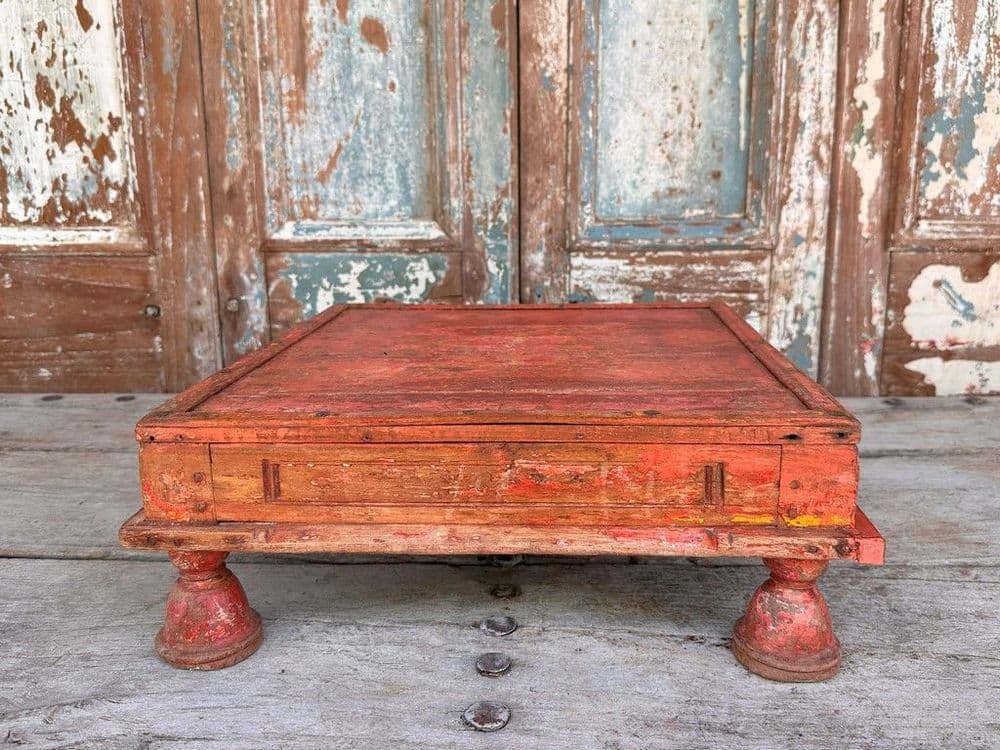 antique hindu shrine table with faded red paint tones
