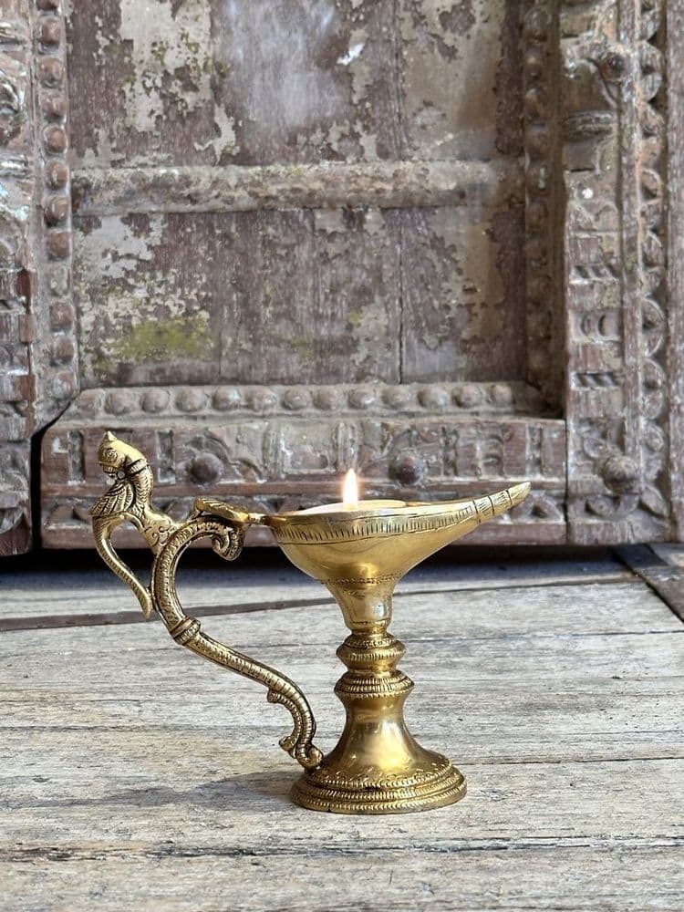 golden brass temple oil lamp with peacock handle
