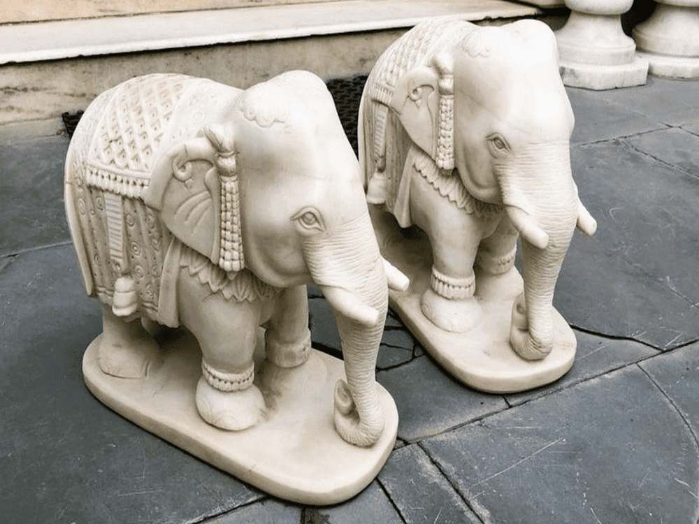 Pair of finely carved marble elephants with carapace decoration