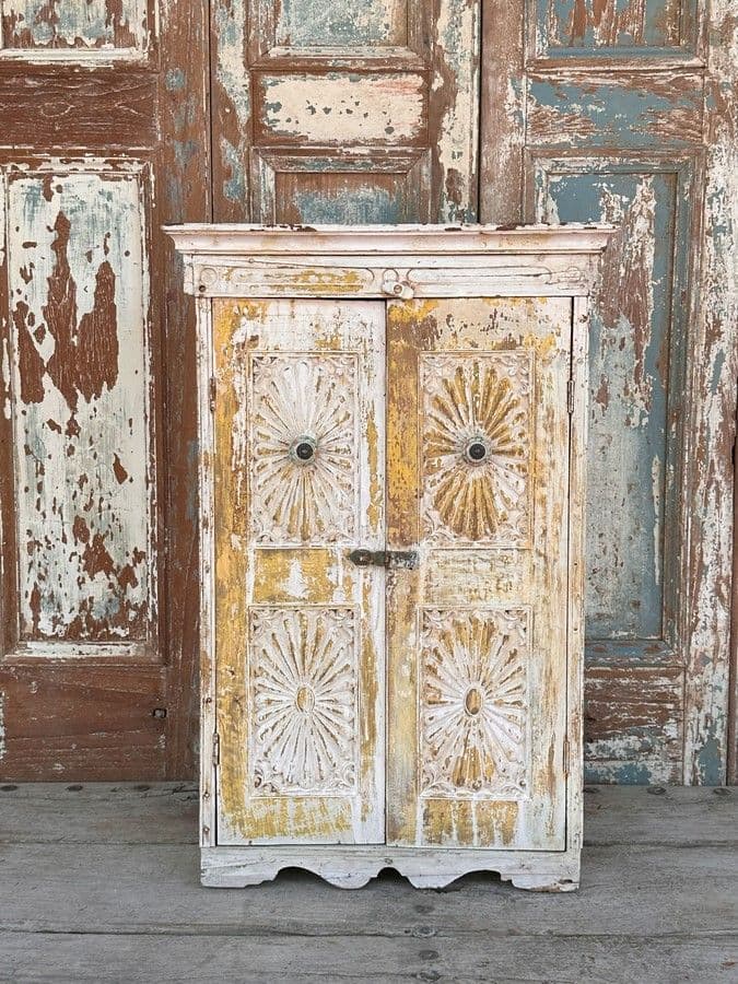 small sunburst colonial cupboard with ochre and cream paint tones