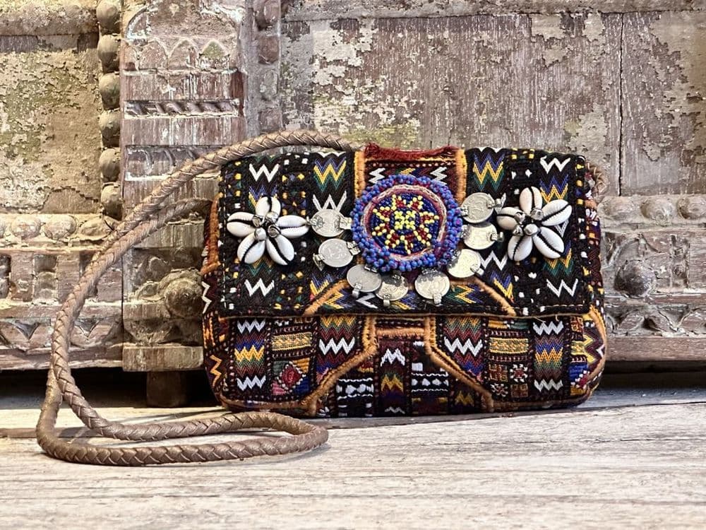 vintage textile bag with coin and cowrie shell embellishment