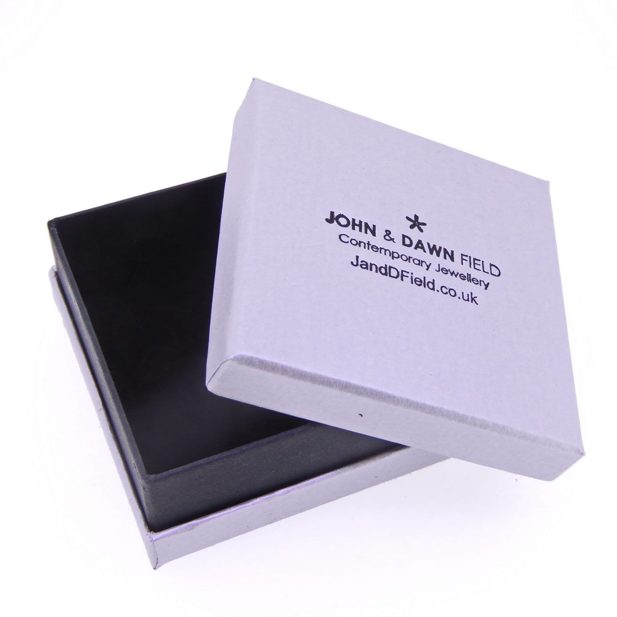 Matching small silver earrings featuring green spinel gemstones